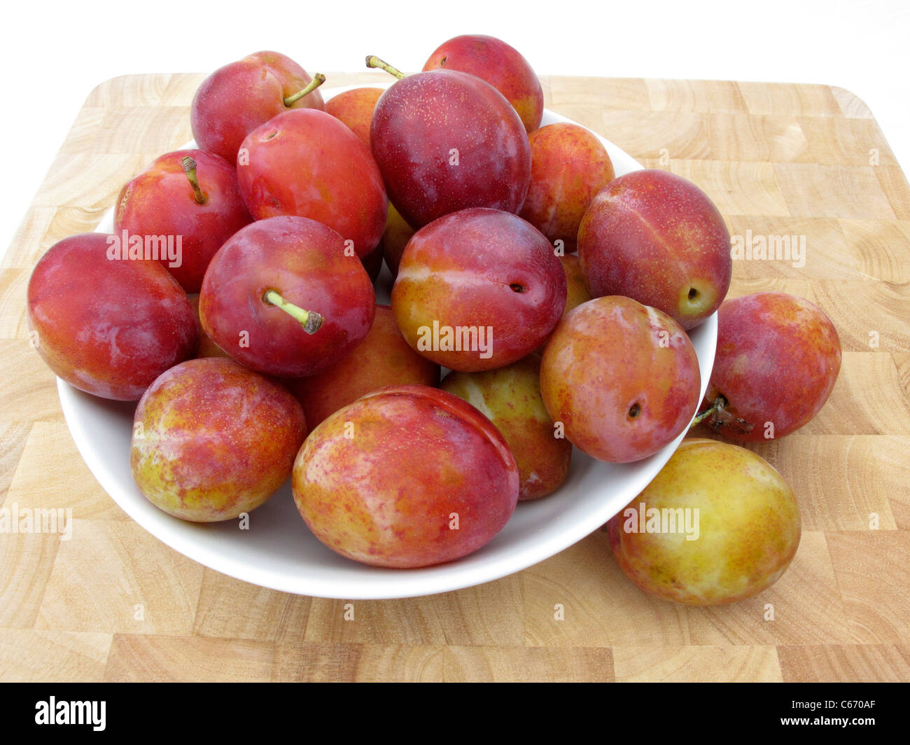 Victoria Plums in a White Bowl Stock Photo - Alamy