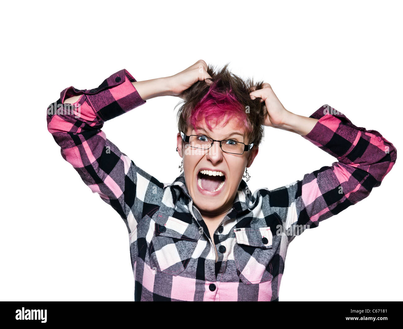Portrait of an angry woman screams and pulls her hair in frustration in ...