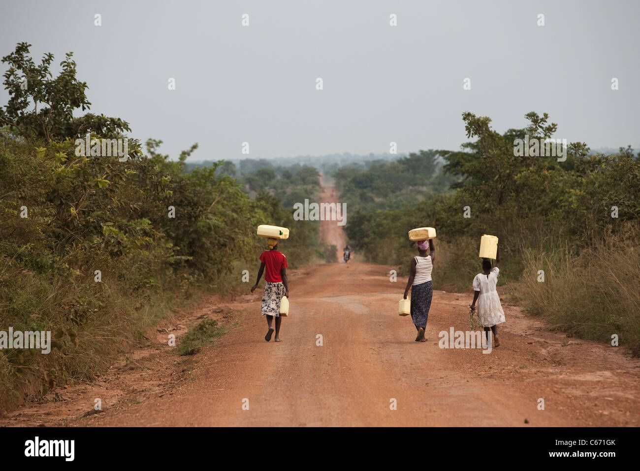 Women carry water along the road from Soroti to Amuria Town. Amuria ...