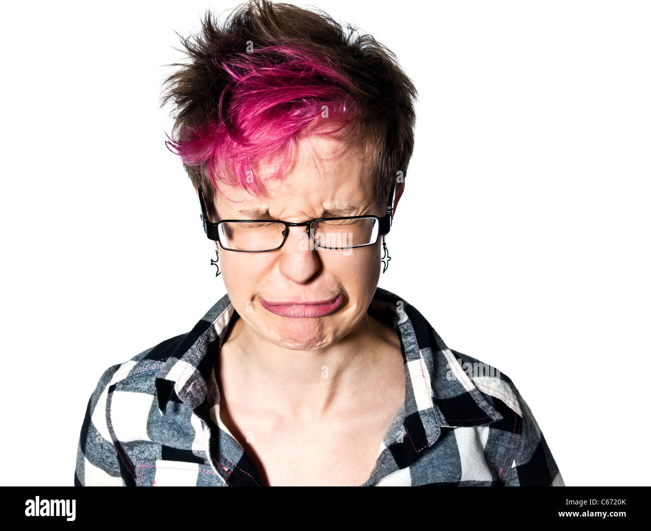 Close-up of a trendy young expressive woman crying in studio on white ...