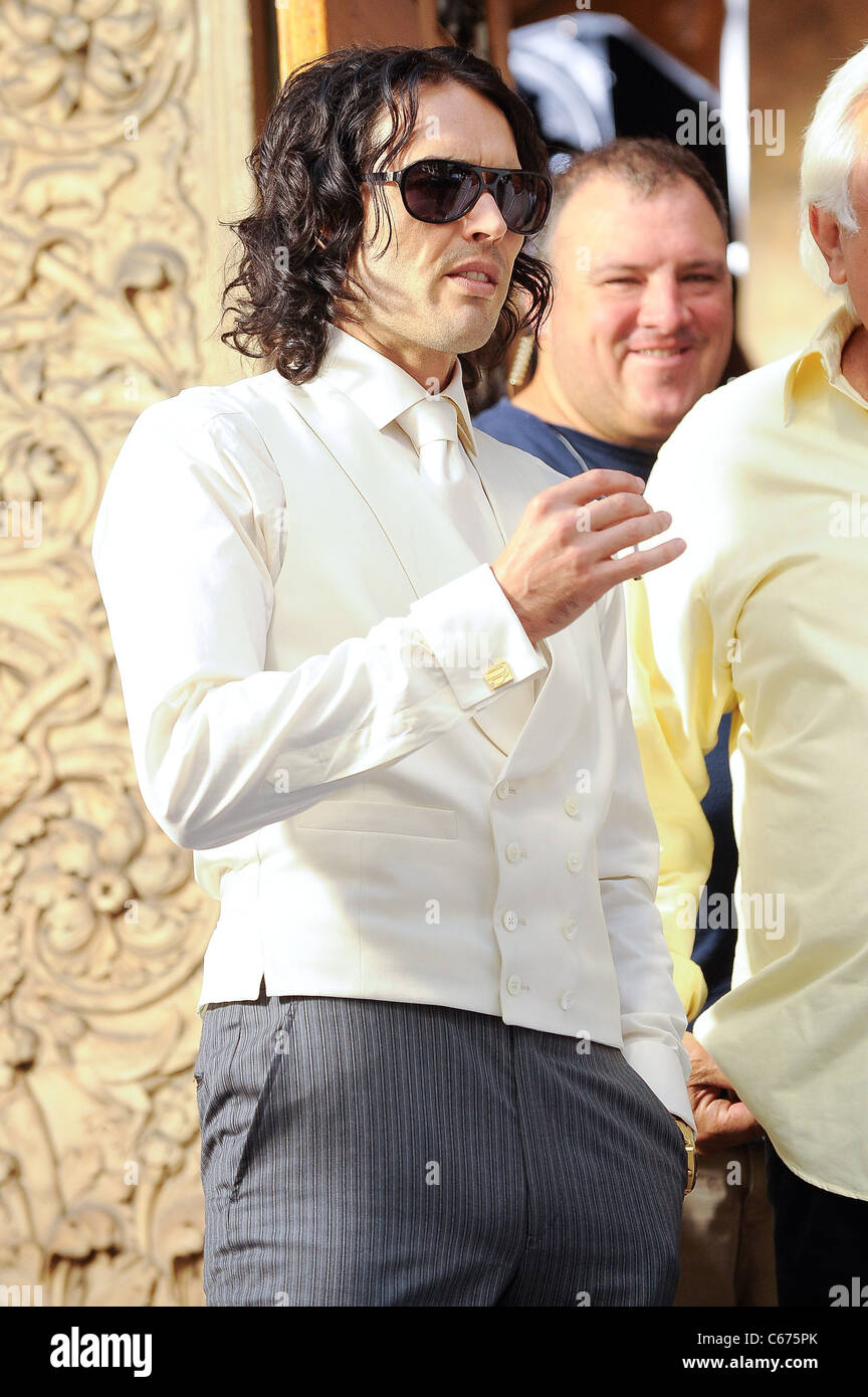 Russell Brand, walks to the 'Arthur' film set in St. Bartholomew's ...