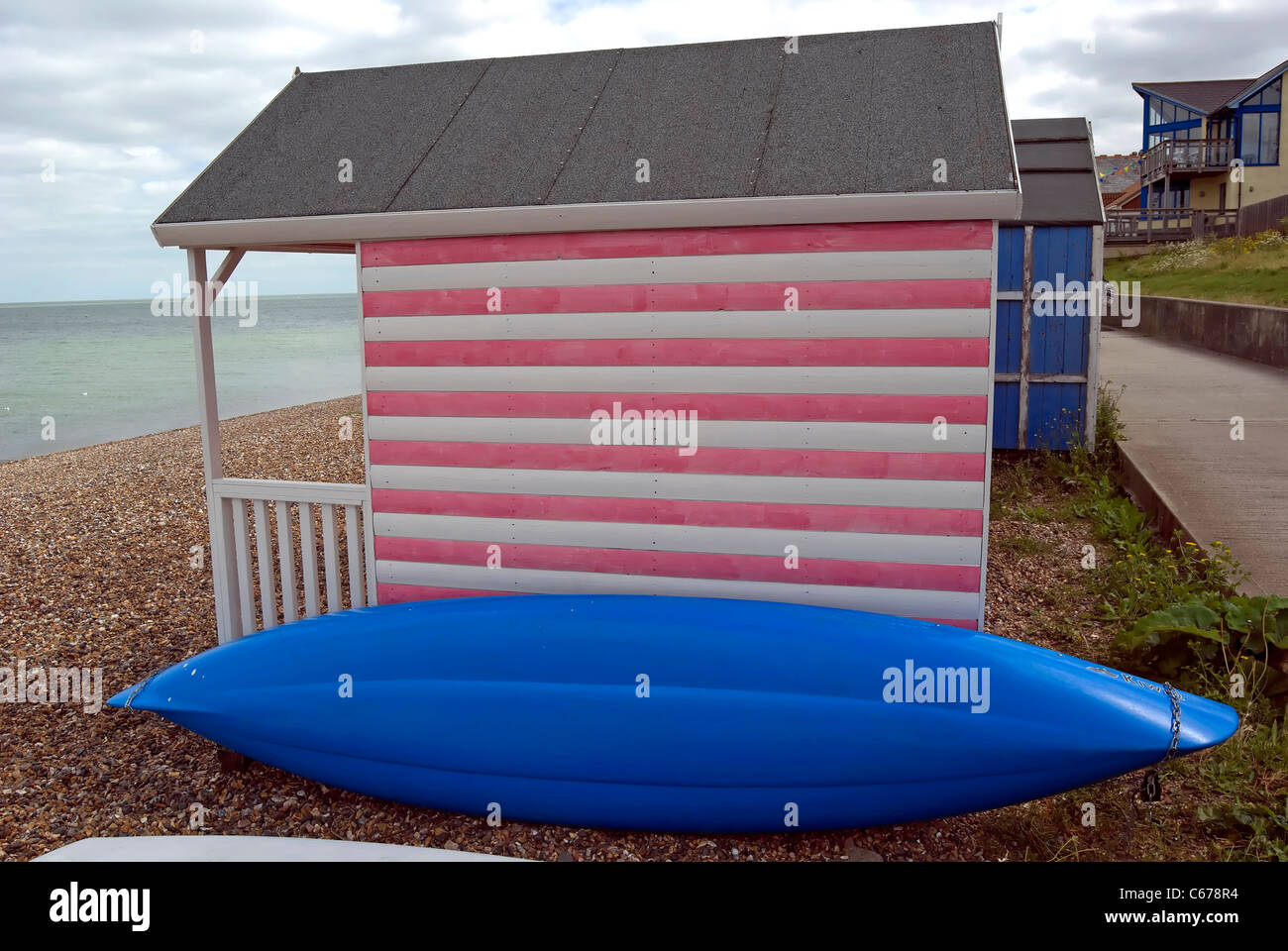 beach hut with surfboard chained alongside, in herne bay, kent, england ...
