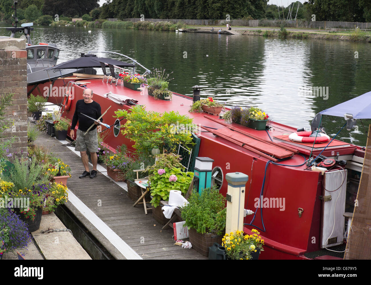 Kingston on Thames, Surrey (London UK) - a narrowboat owner (houseboat ...
