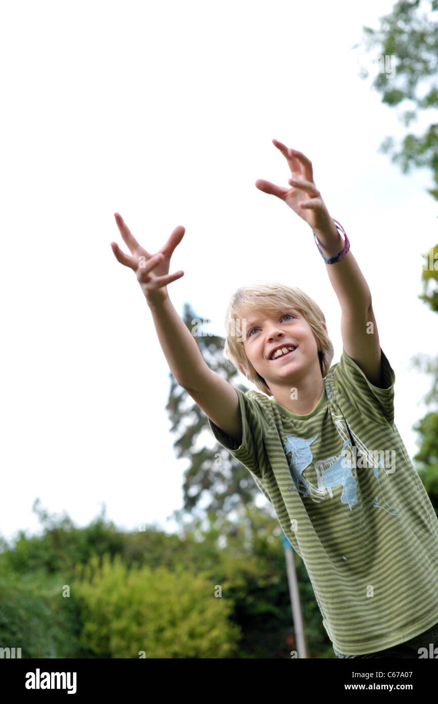 Boy stretching to reach hi-res stock photography and images - Alamy