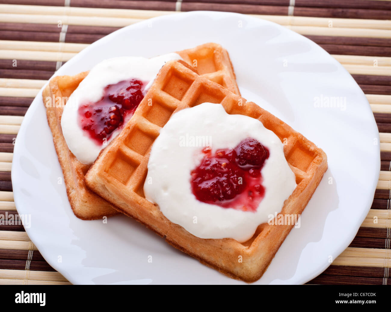 dessert with soft waffle and raspberry jam Stock Photo - Alamy