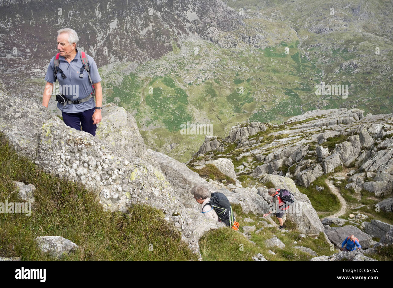 Ogwen, Conwy. North Wales, UK. Walkers scrambling on Tryfan north ridge ...