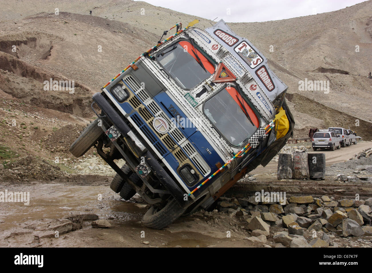 Decorated Indian truck after traffic accident on a muddy Himalayan ...