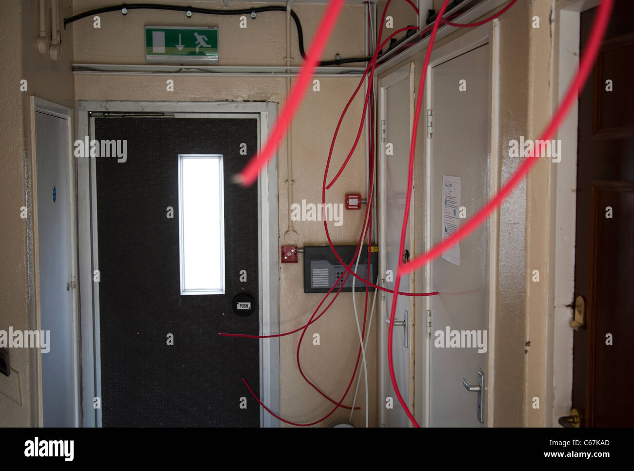 Cables hanging during the 1st fix for a Fire Alarm Stock Photo - Alamy