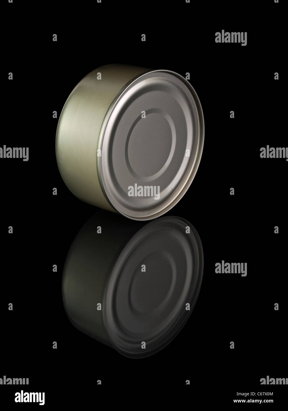 A golden tuna fish tin can and its reflection, isolated on black Stock ...