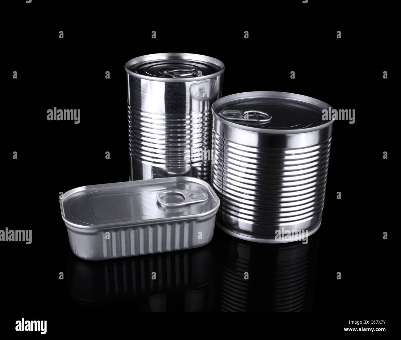 Three different unopened tin cans isolated on black Stock Photo - Alamy