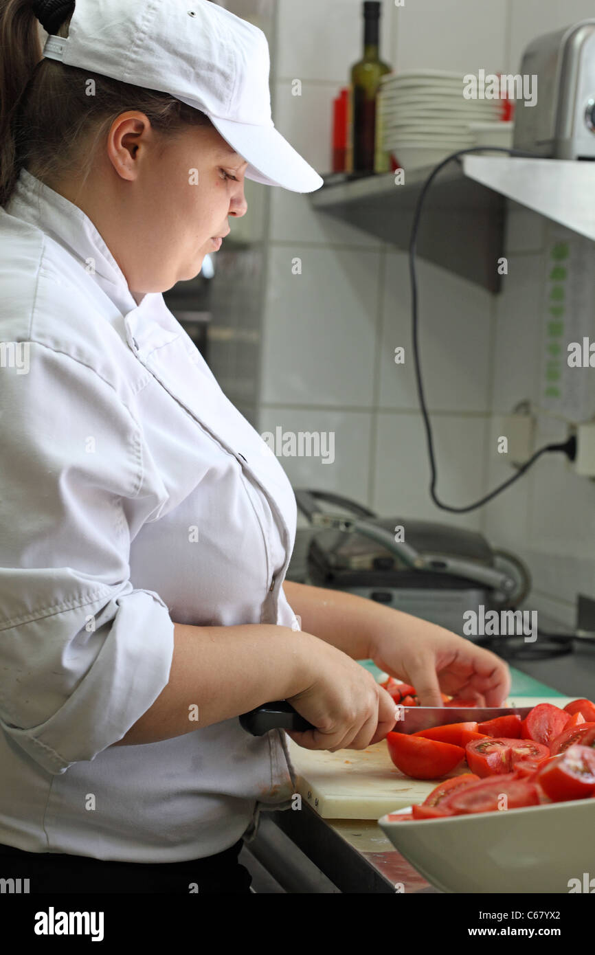 Lady chef carving tomato salad Stock Photo - Alamy