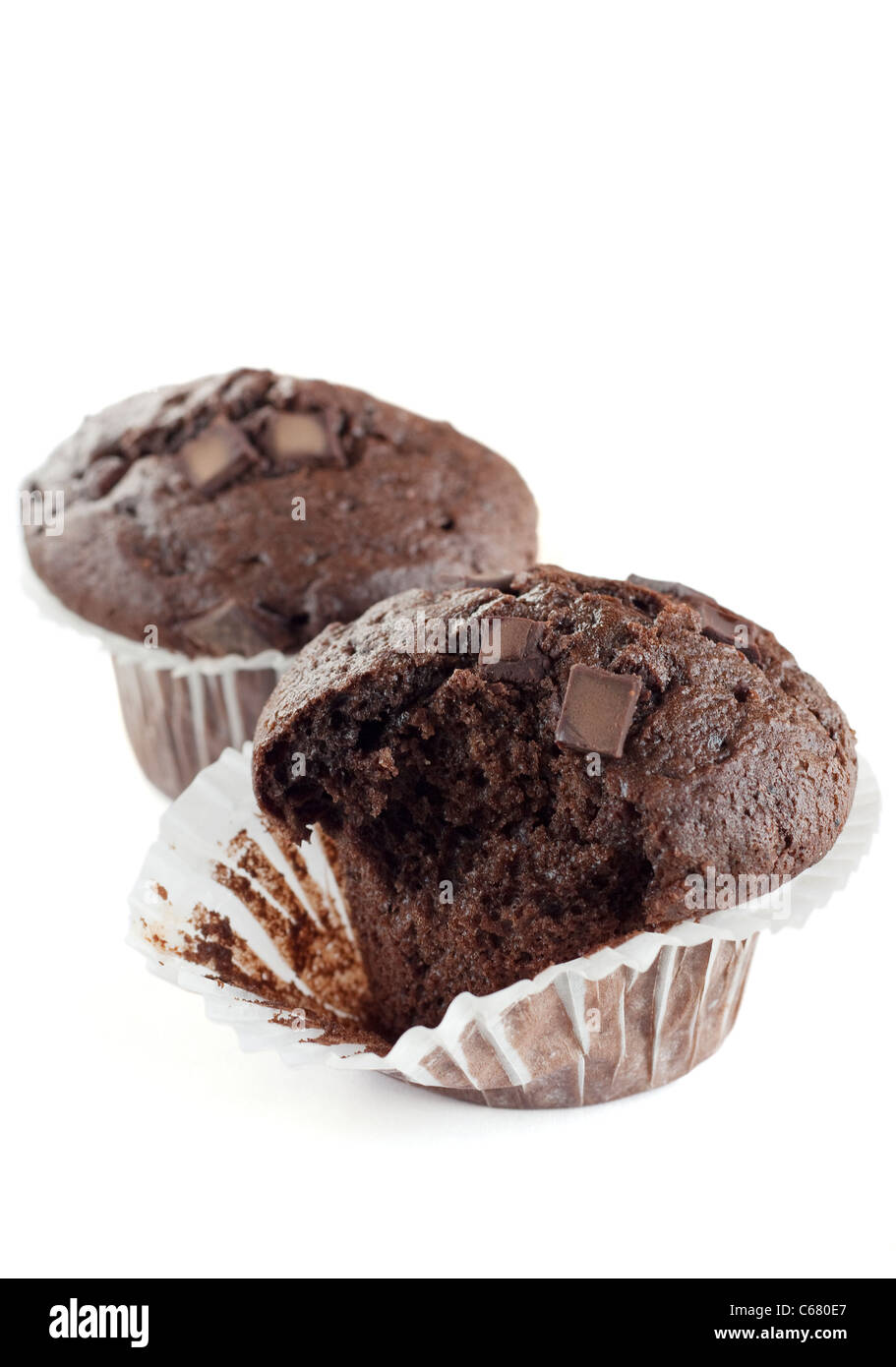 Two double chocolate muffins on a white background Stock Photo - Alamy