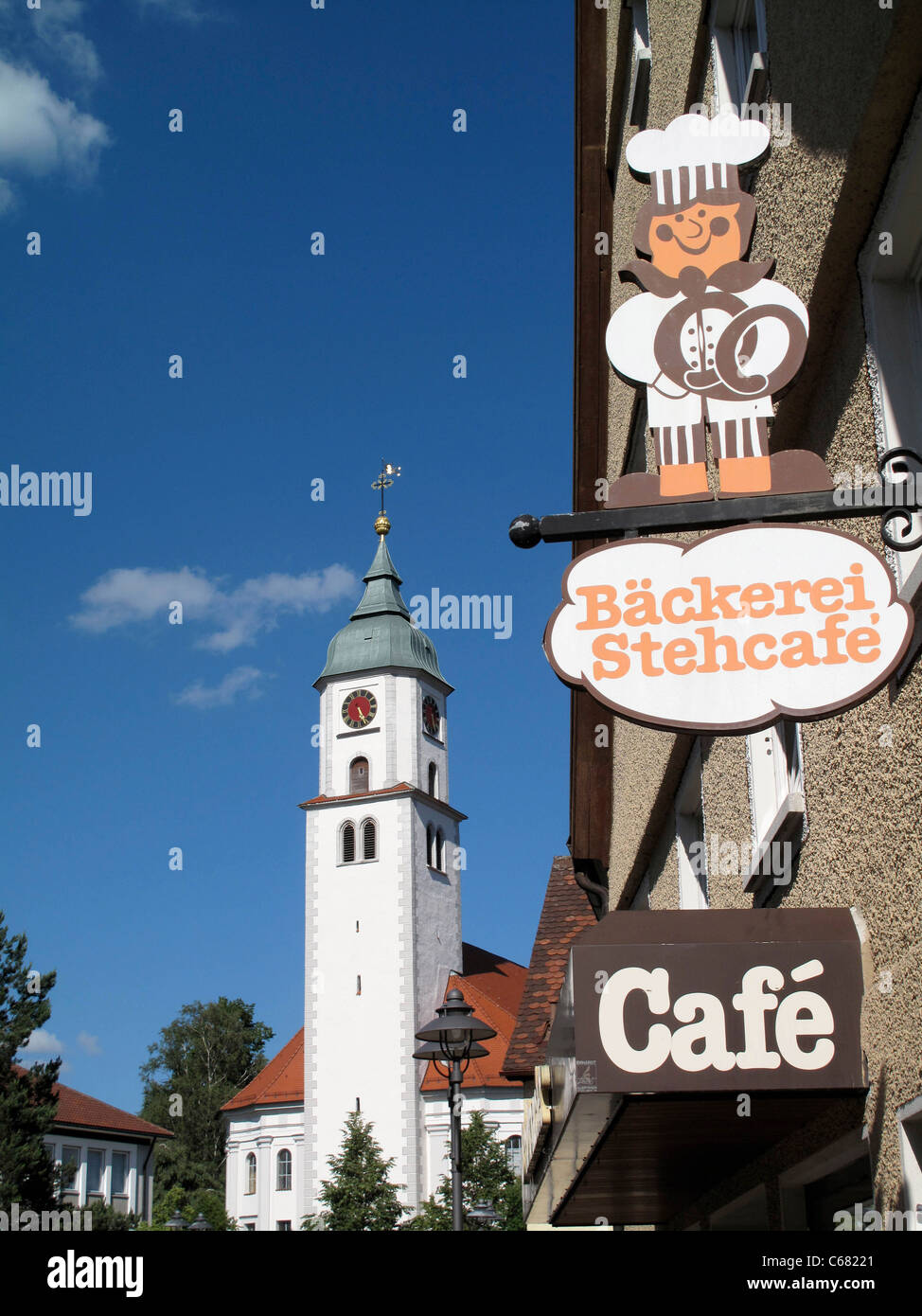 Close-up of Bakery store sign and Catholic church in background, Bad ...