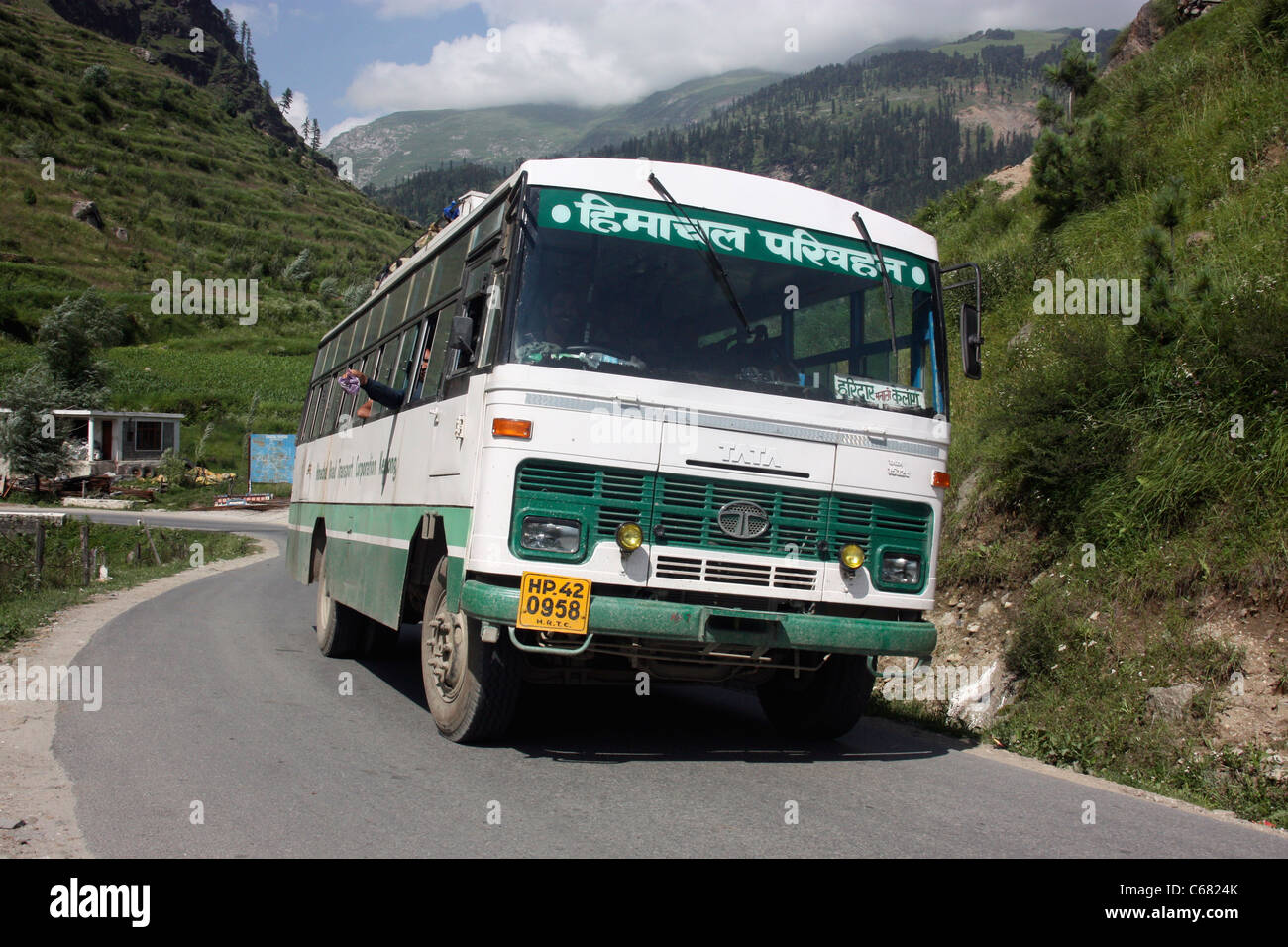 State bus winds its way up a mountain road from Manali in the Himalayas ...