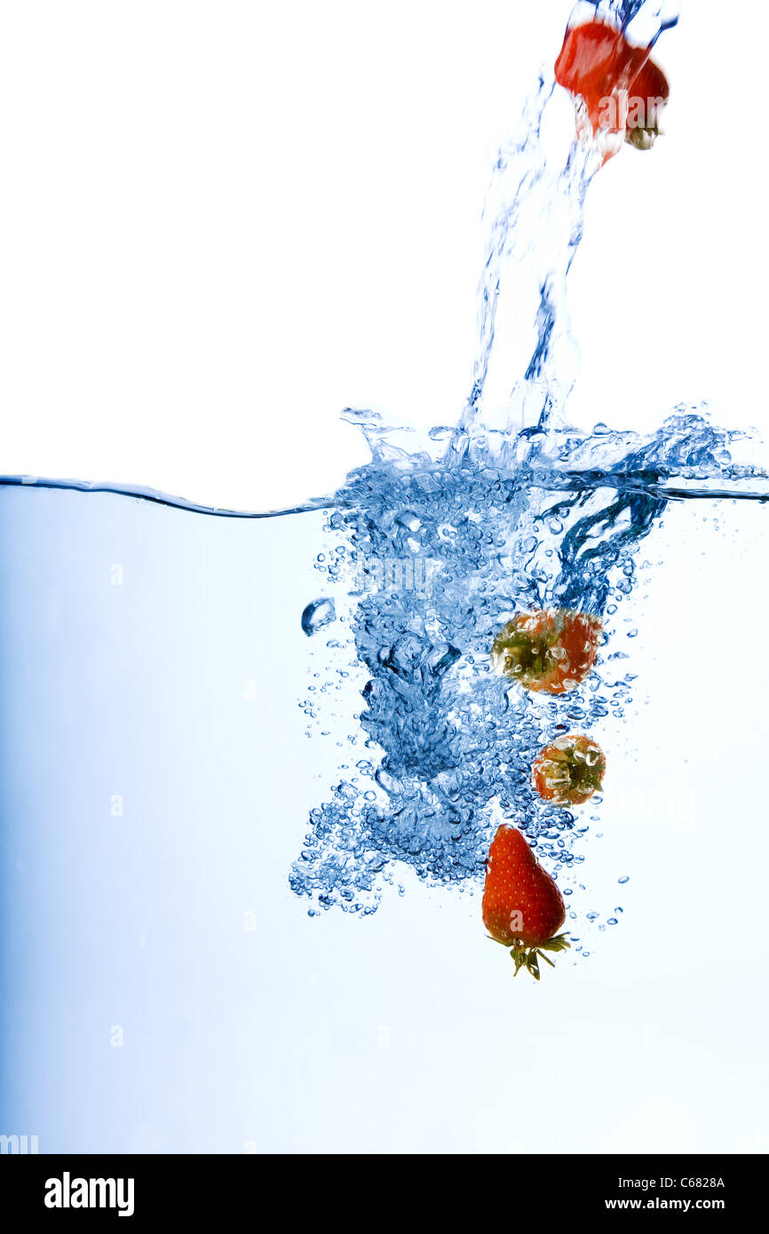 Fresh strawberries in water splash hi-res stock photography and images ...