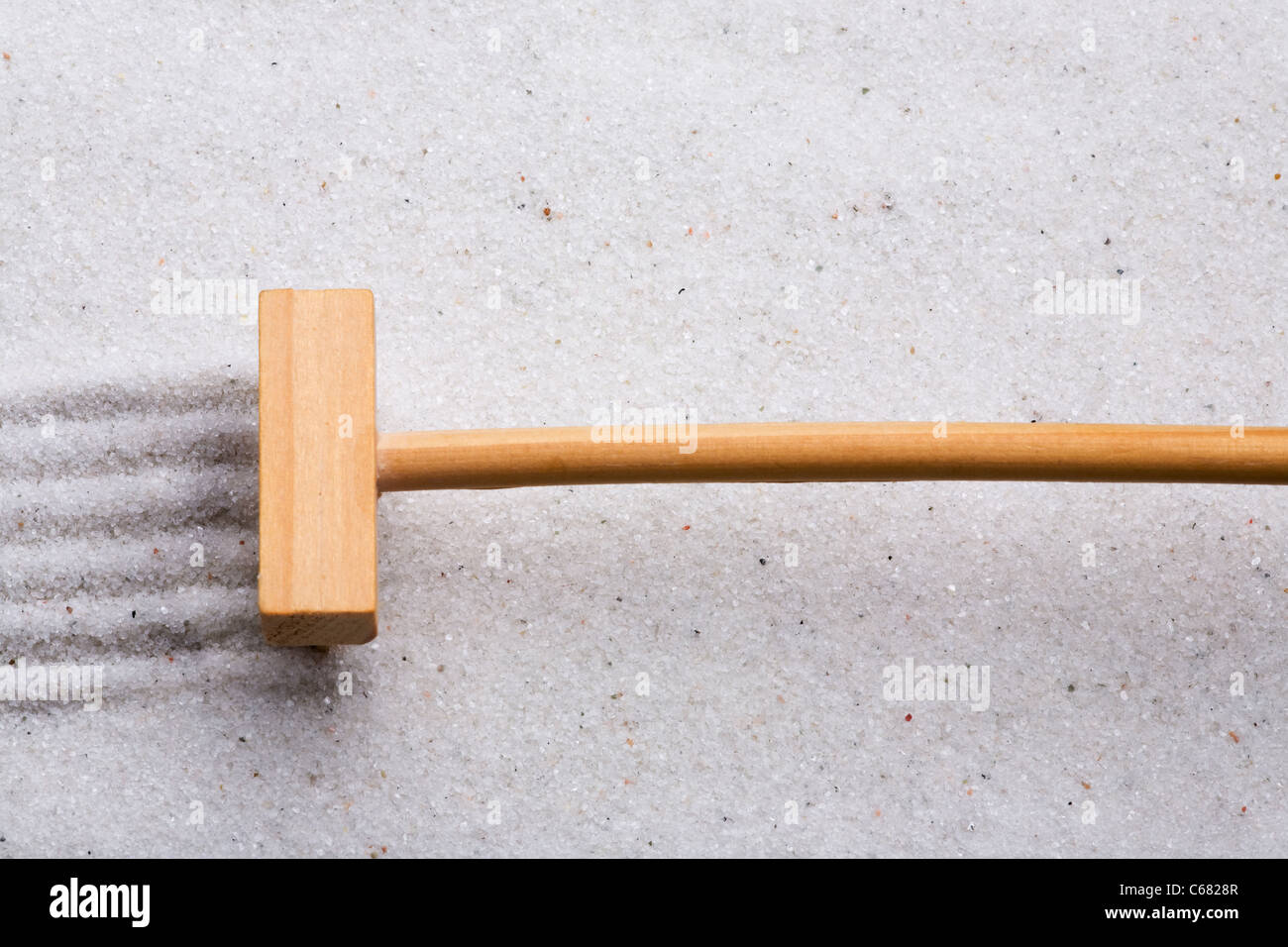 A small rake, creating a design in a zen garden Stock Photo - Alamy