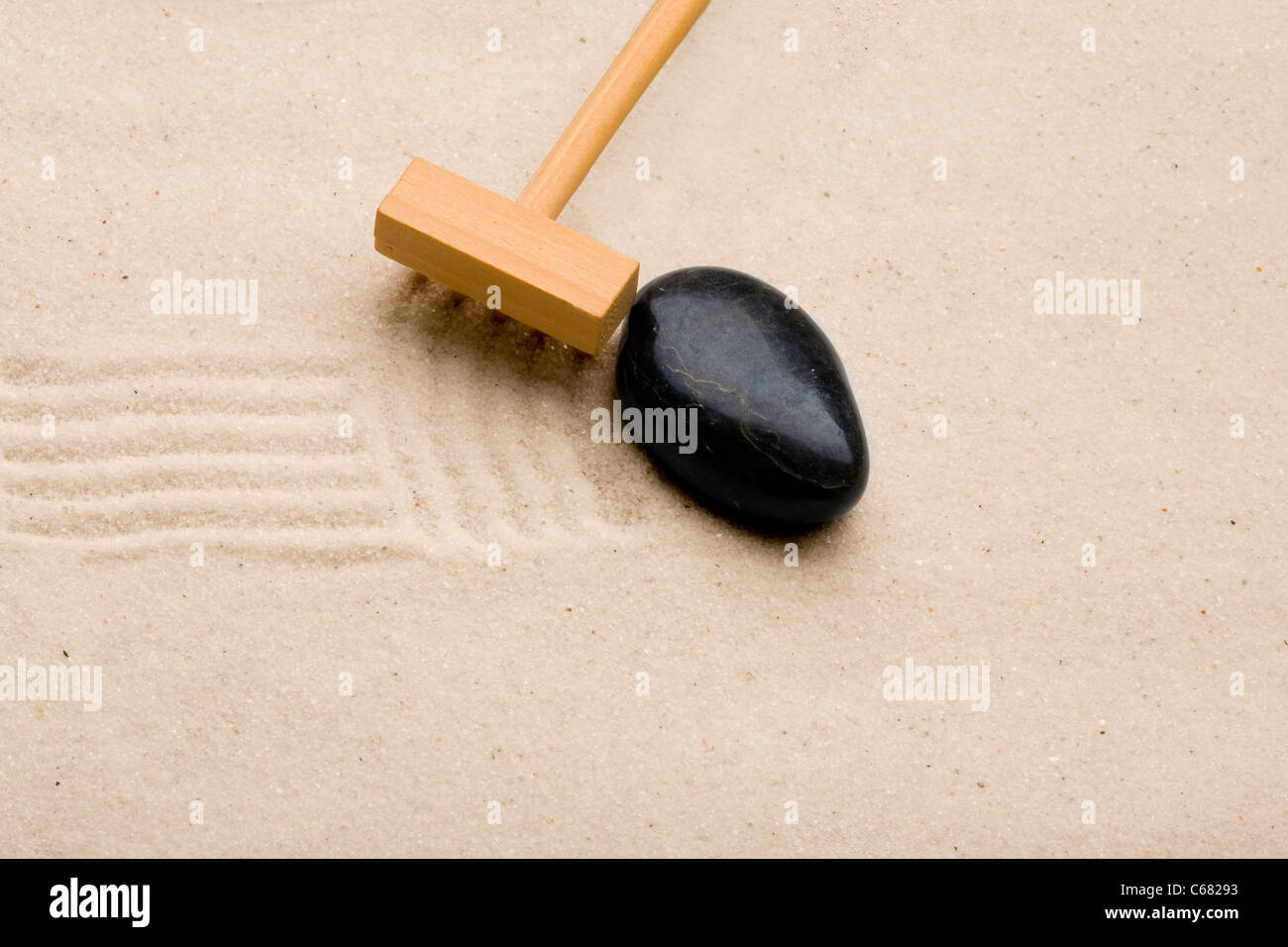 A small rake, creating a design in a zen garden Stock Photo - Alamy