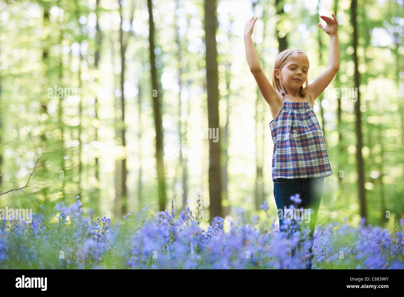 Girl dancing in field of flowers Stock Photo - Alamy