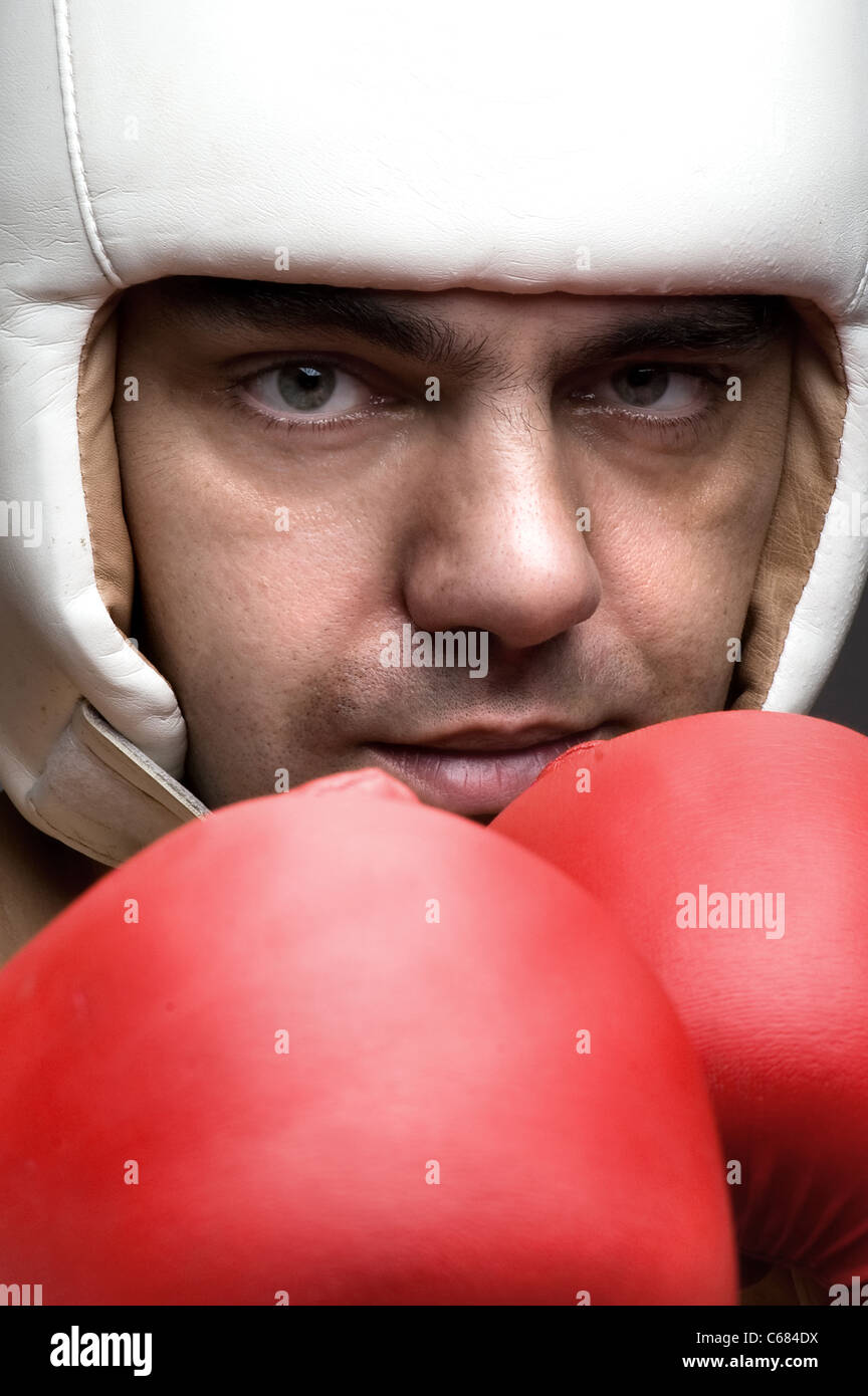 boxer in protective helmet and boxing gloves Stock Photo - Alamy