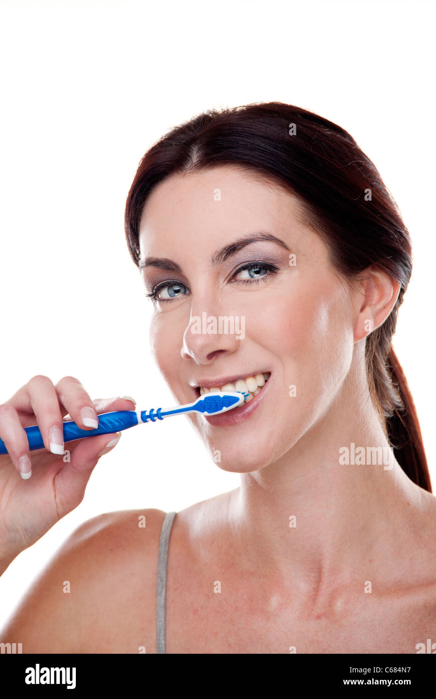 woman brushing her teeth , holding a toothbrush Stock Photo - Alamy