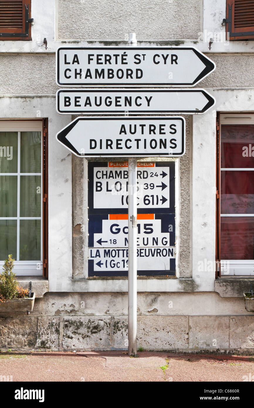 Modern traffic directions signs in front of old Plaque Michelin sign at ...