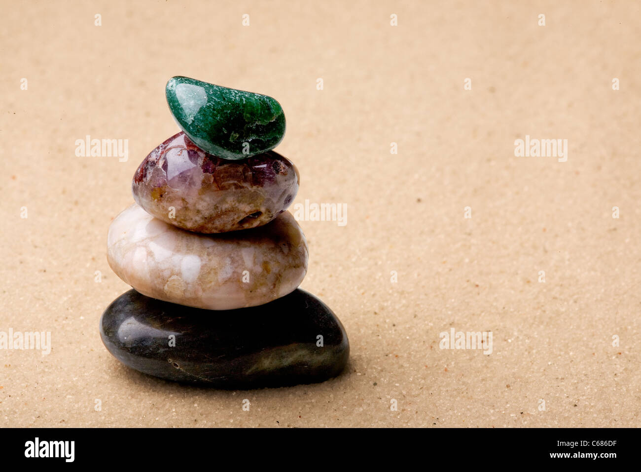 A tower of rocks in a very minimalist zen rock garden Stock Photo - Alamy