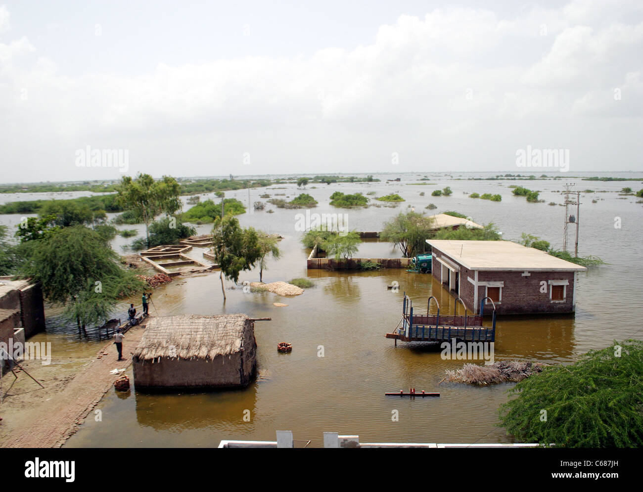 A view of inundated houses at a flood hit area in Badin on Thursday ...