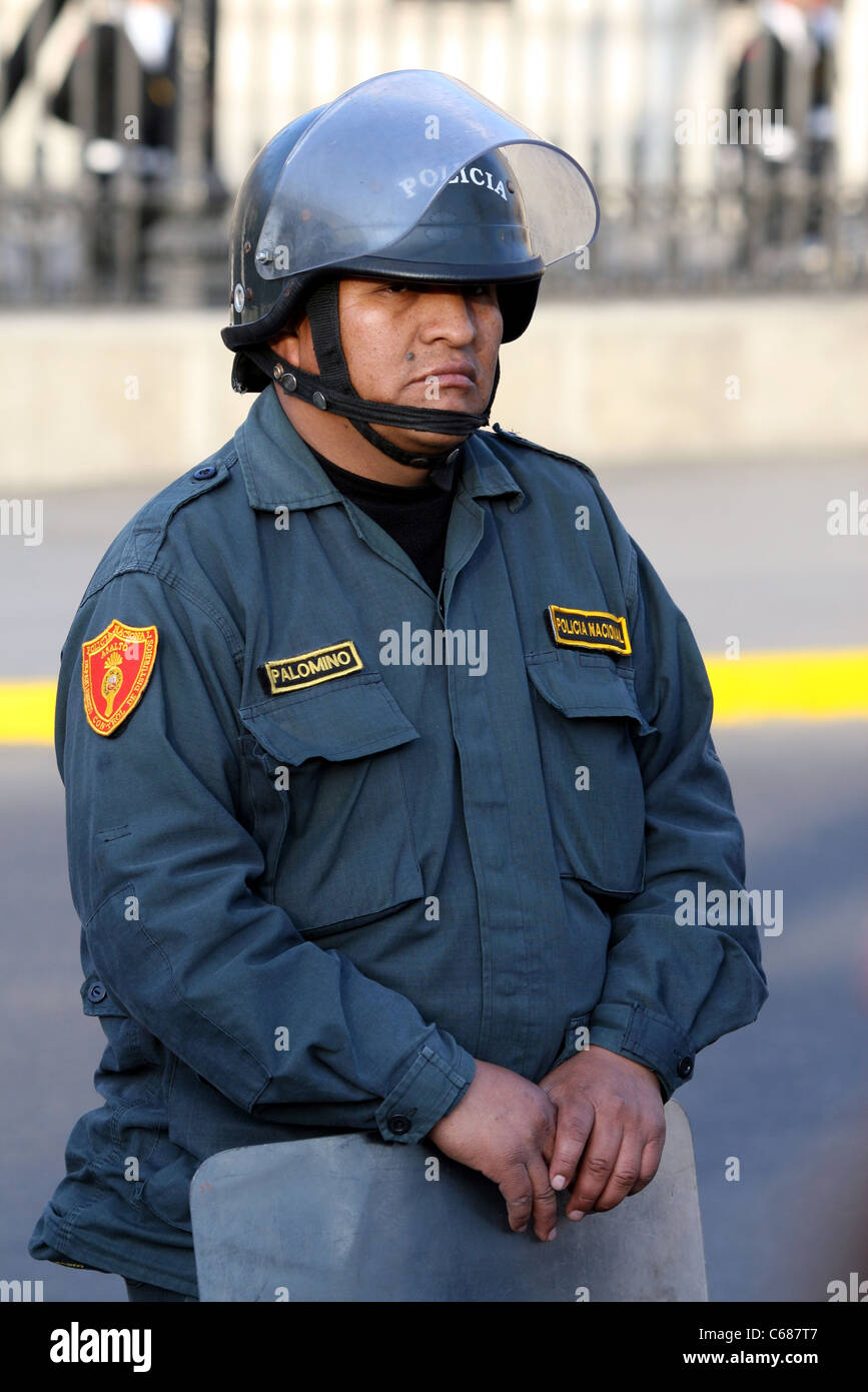 A policeman stands guard outside the Casa de Gobierno in the Plaza de ...