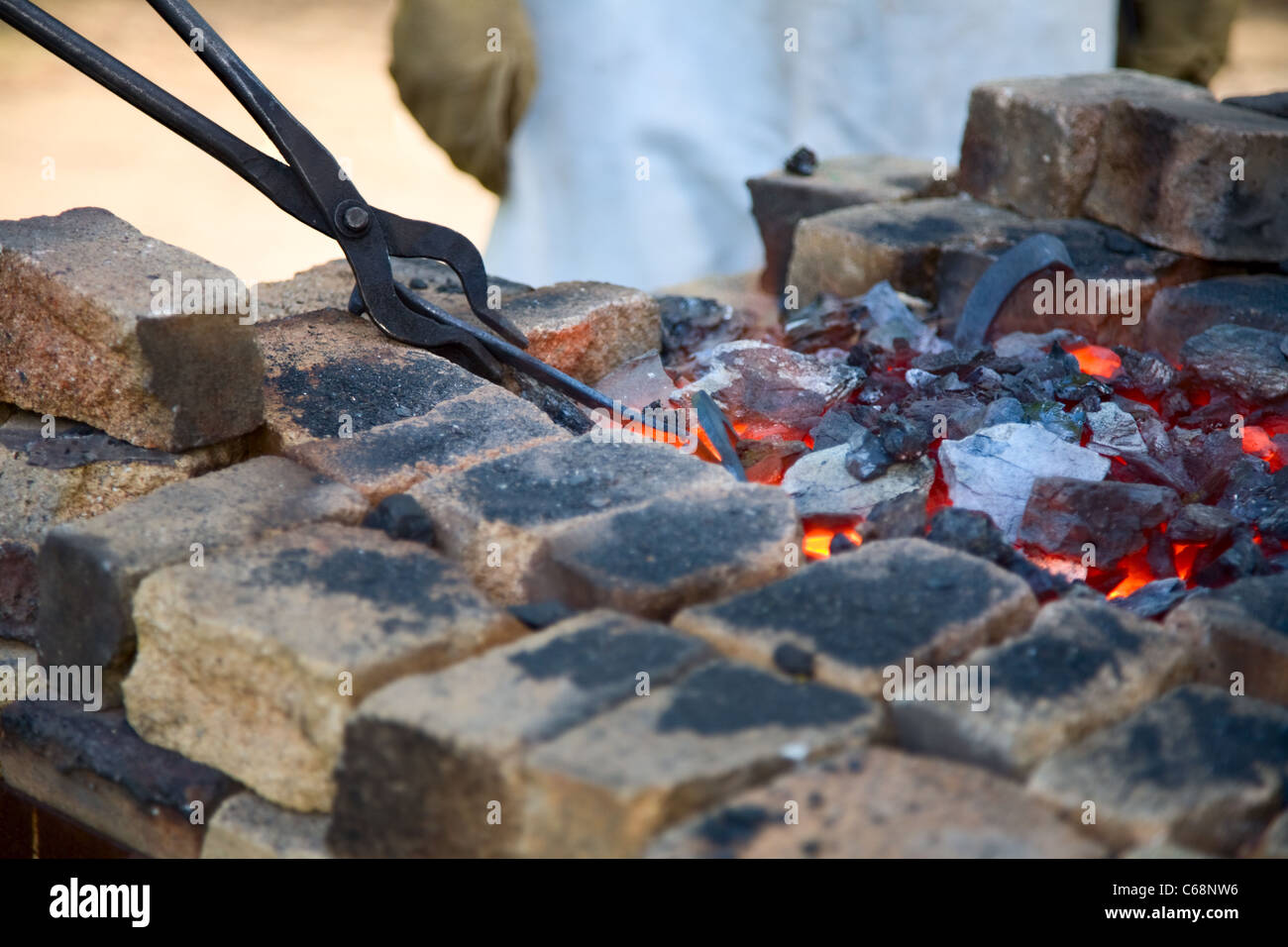 tongs with hot iron horseshoe in smith's hearth Stock Photo - Alamy