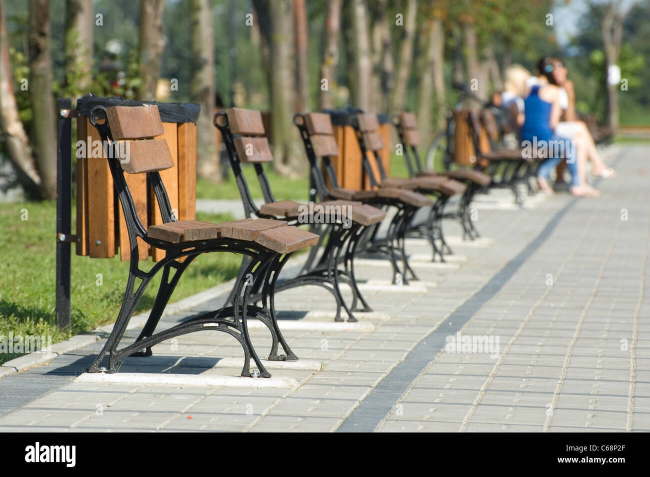 Metallic and wooden benches in a park Stock Photo - Alamy