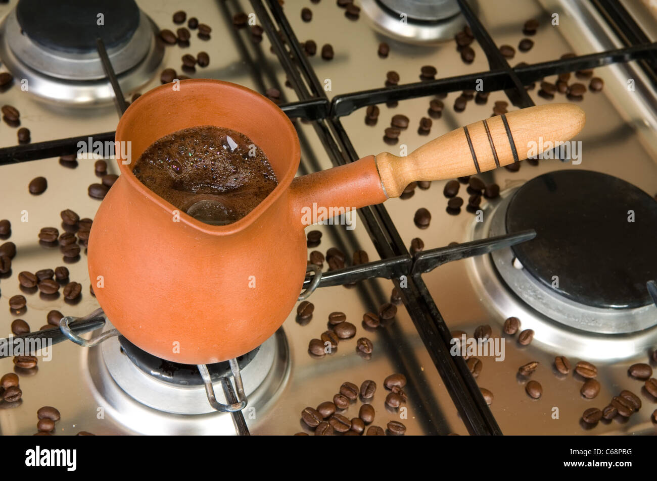 Boiling coffee on a gas cooker Stock Photo - Alamy