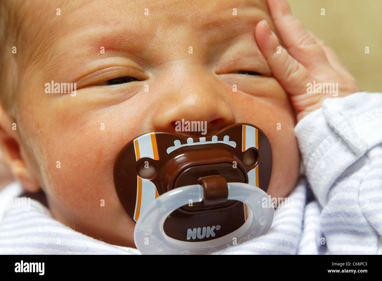 Newborn with a pacifier Stock Photo - Alamy
