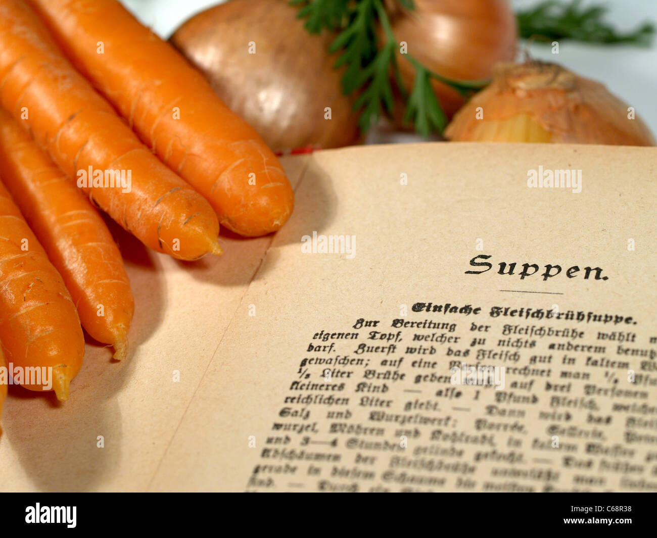 an old German cookbook side by side with carrots and onions Stock Photo ...