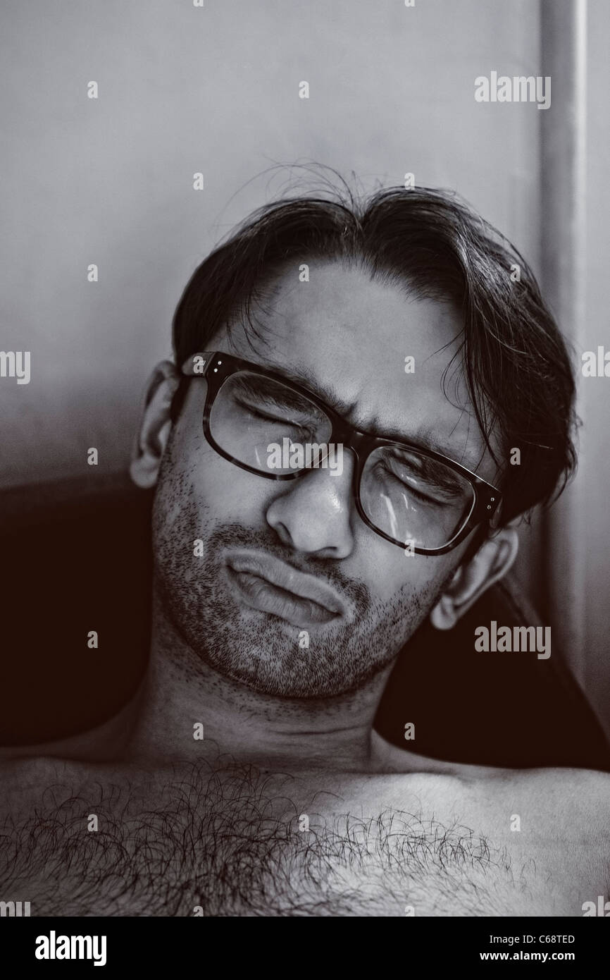 screwed-up face of a young man in glasses Stock Photo - Alamy