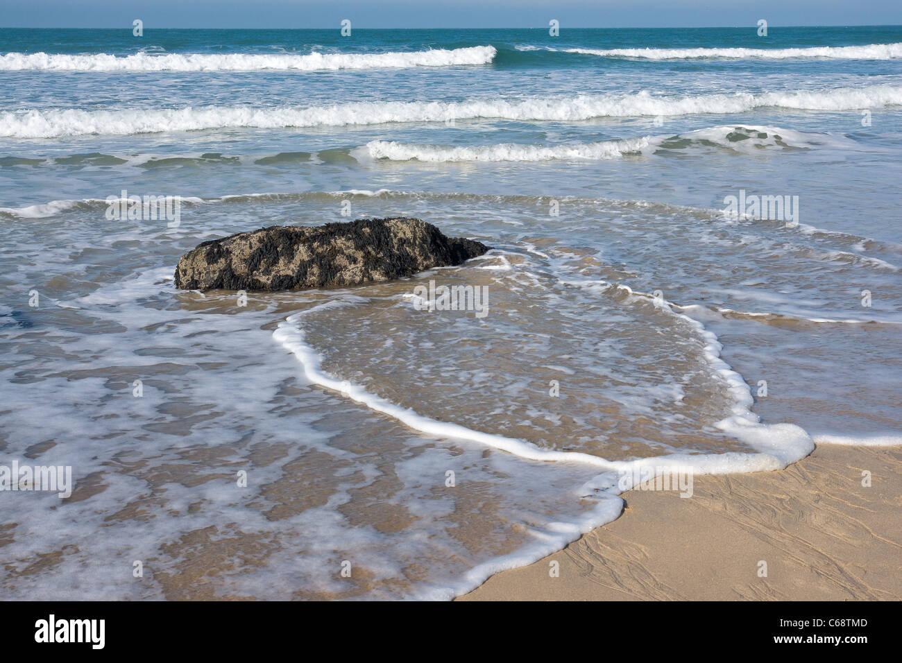 Incoming tide and waves Stock Photo - Alamy