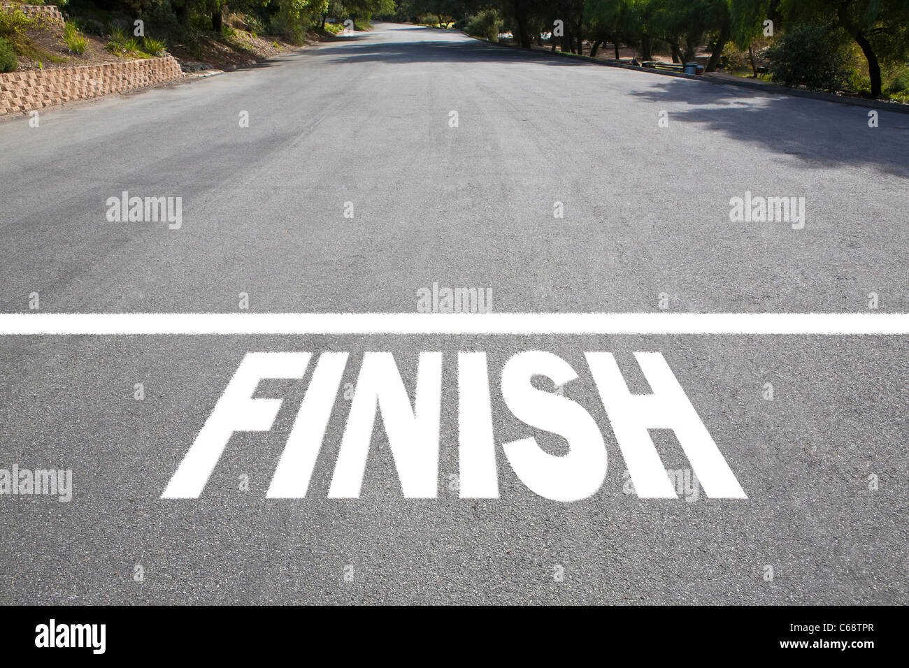 empty tree-lined road and parking lot with finish line Stock Photo - Alamy