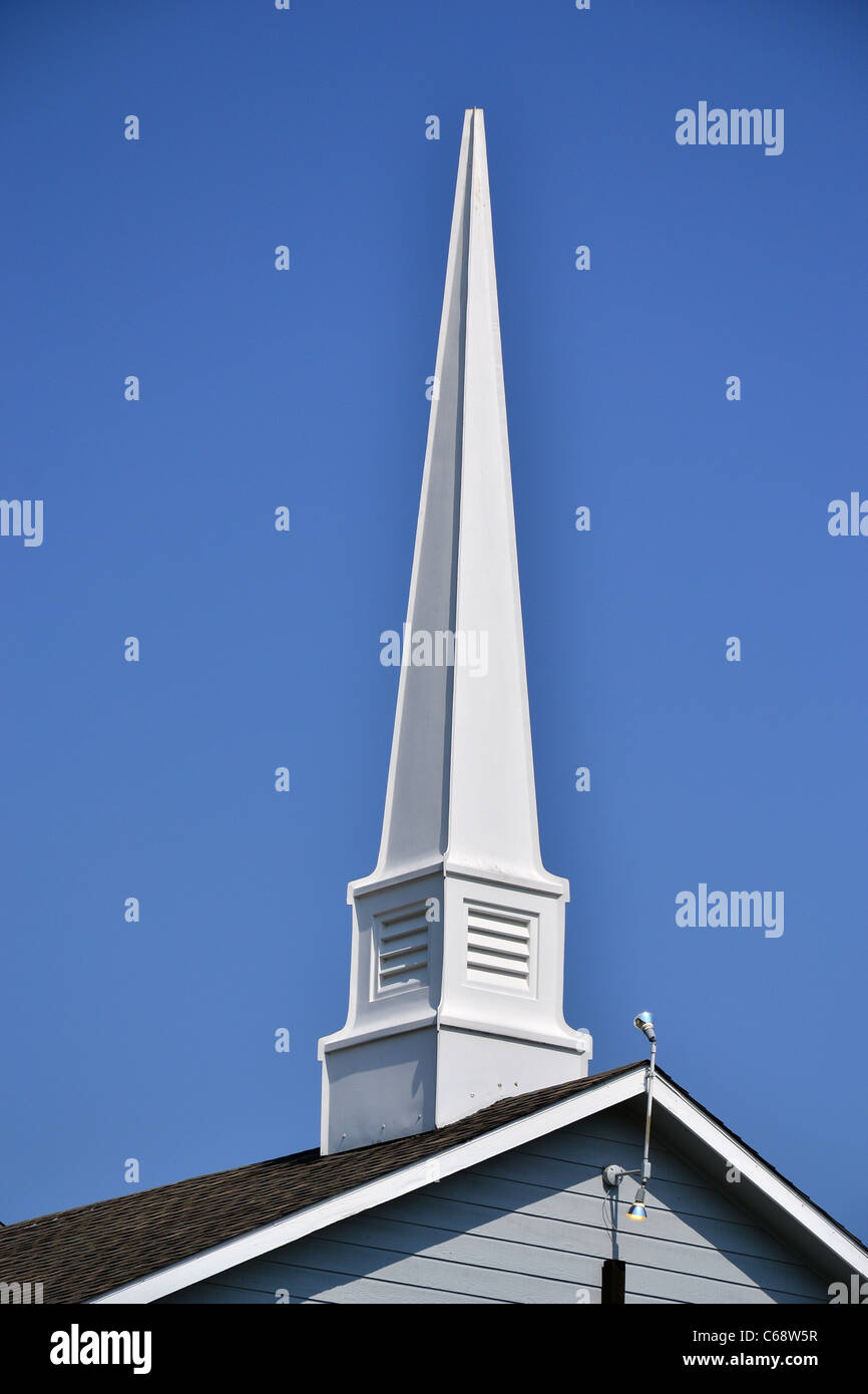 A view of a white church steeple on a blue sky background Stock Photo ...