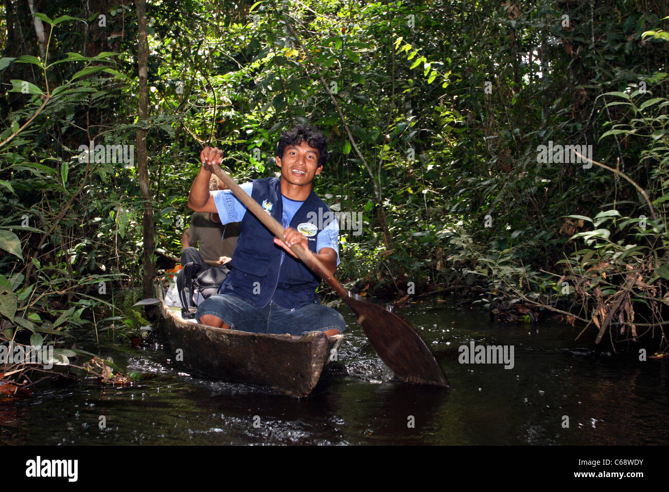 A jungle guide paddles a short-cut through flooded forest on Rio ...