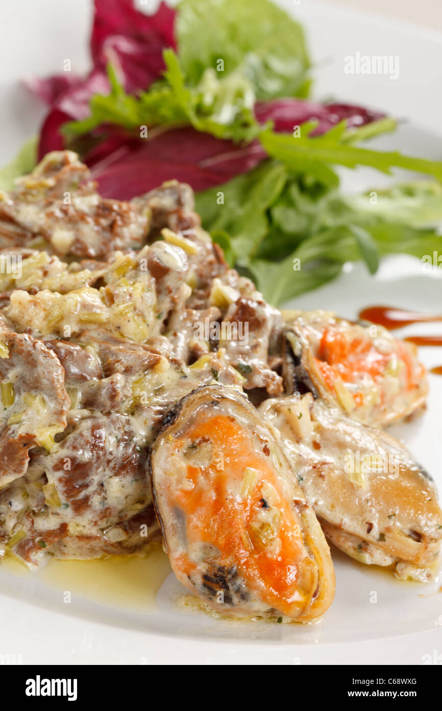Fricassee with seafood and salad Stock Photo - Alamy