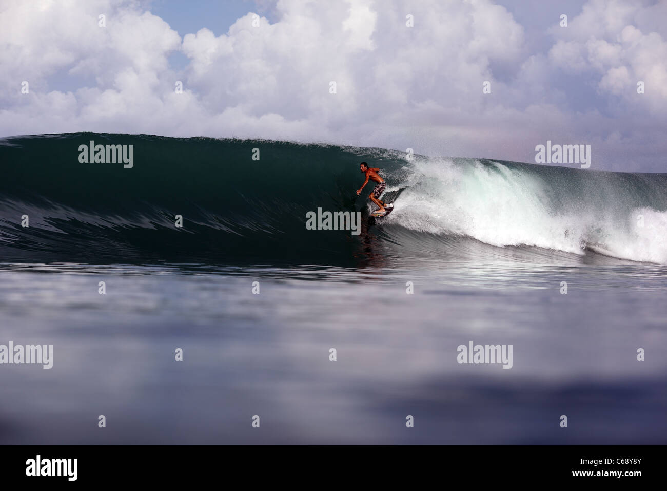 Surfer riding a perfect wave somewhere in Sumatra, Indonesia Stock ...