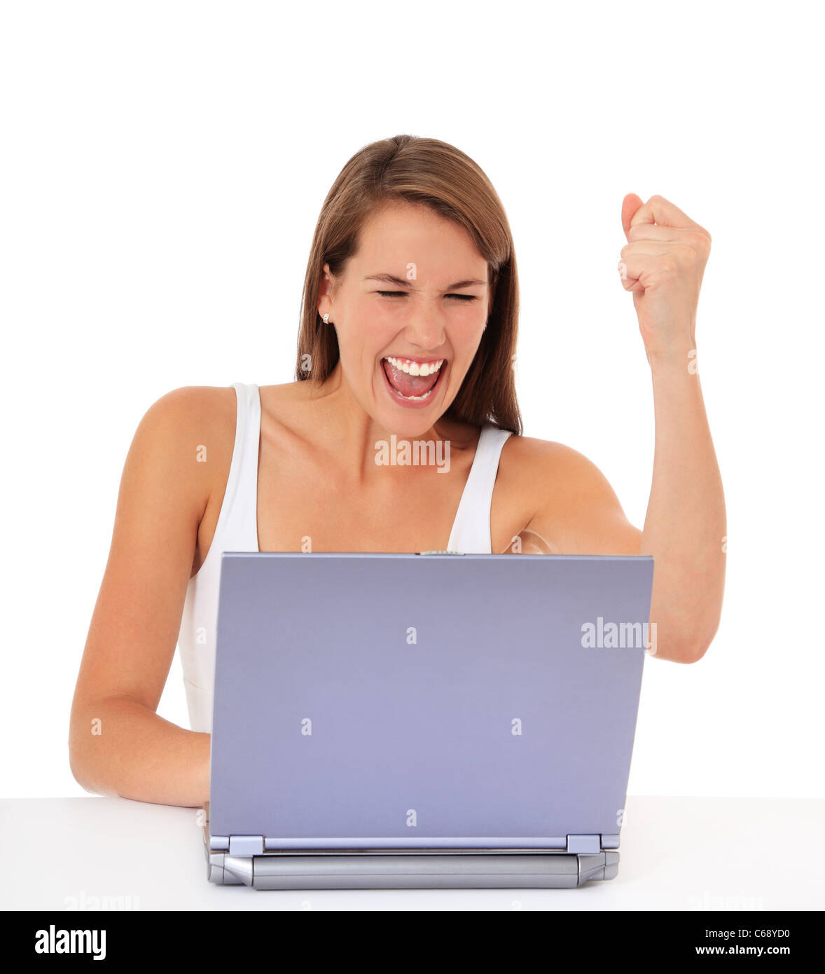 Attractive young woman cheering while using laptop. All on white ...