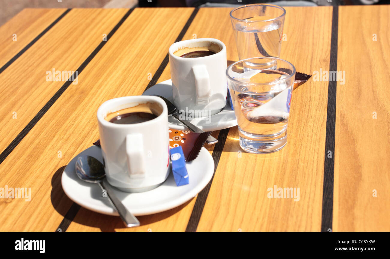 cups of coffee with a glass of water Stock Photo - Alamy