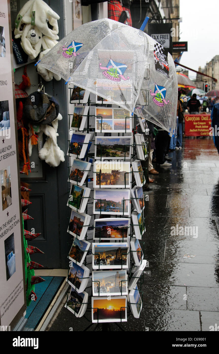 See through umbrella protecting stock of picture postcards on a rack ...