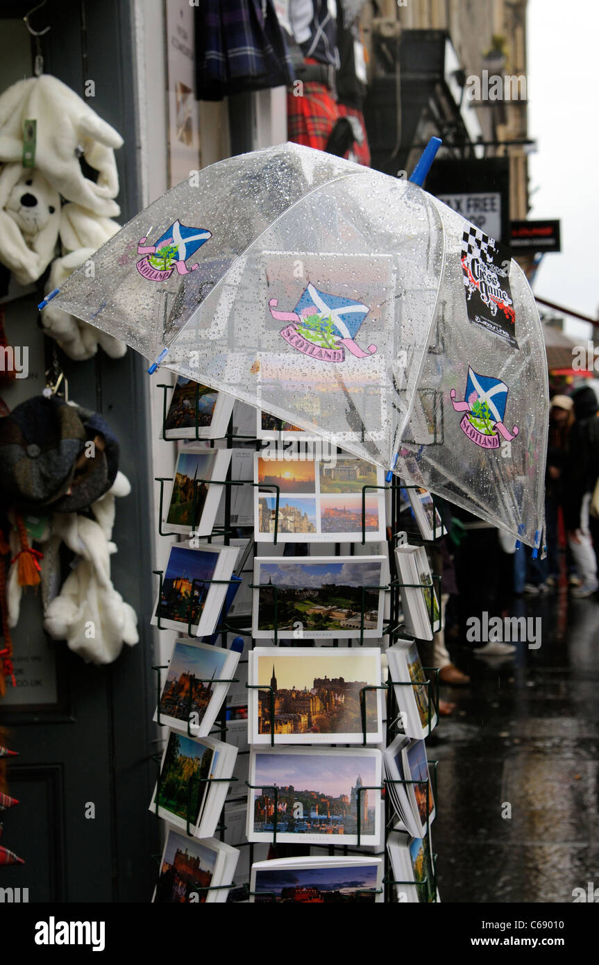 See through umbrella protecting stock of picture postcards on a rack ...