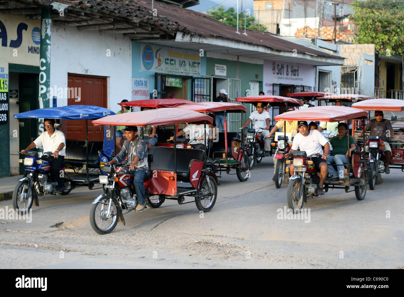 Motor taxi tuk tuk and passengers in the town bordering the Amazon ...