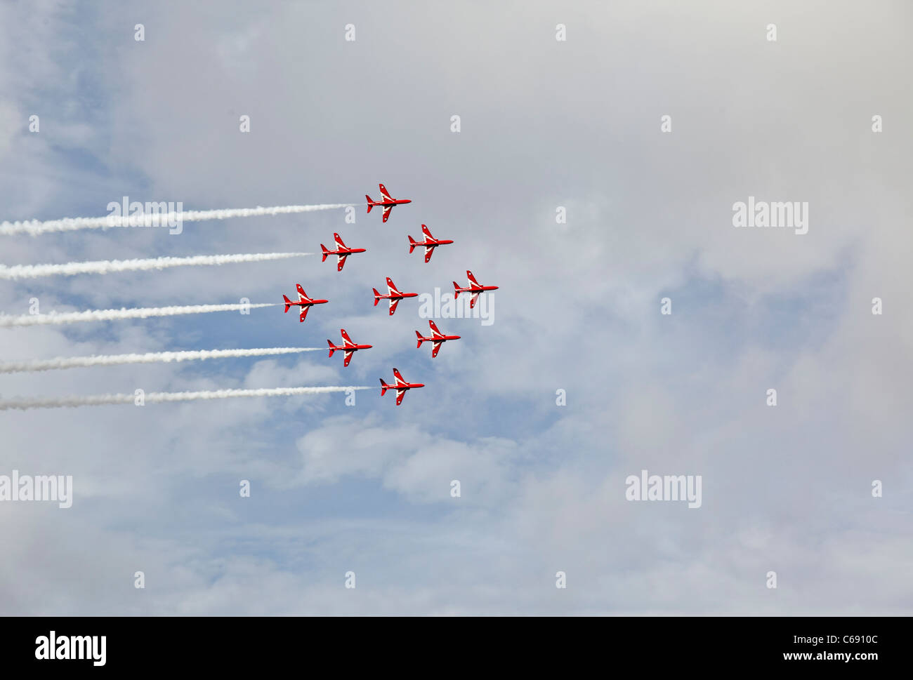 The Red Arrows fly against a cloudy sky Stock Photo - Alamy