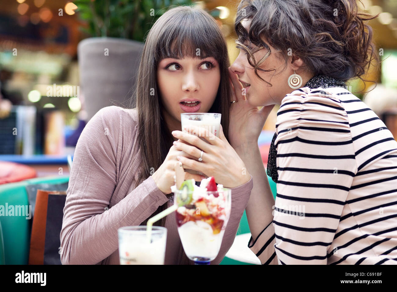 two young girls having lunch break together Stock Photo - Alamy
