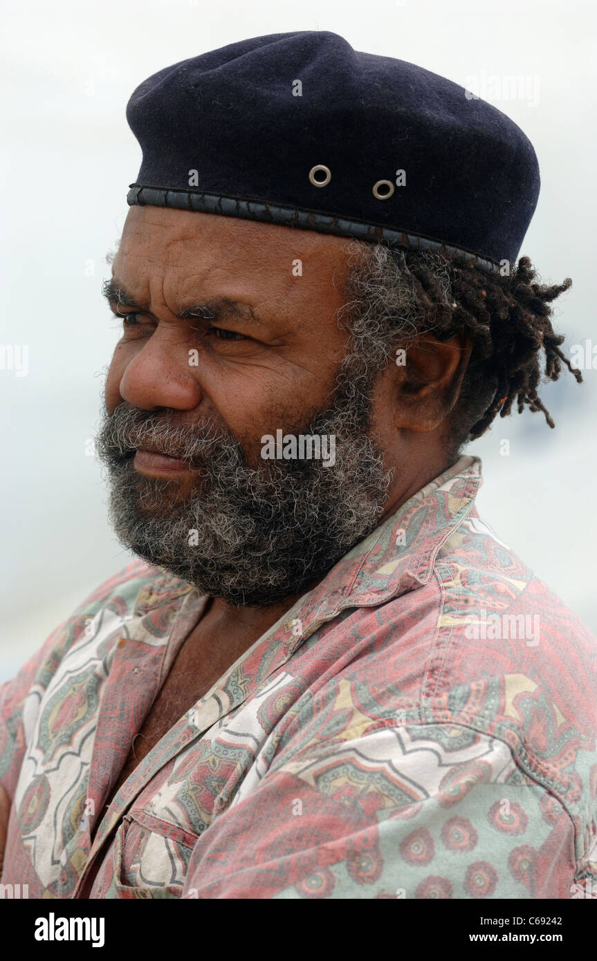 Kanak man's looking a boat of cruising arriving at Noumea's harbour ...