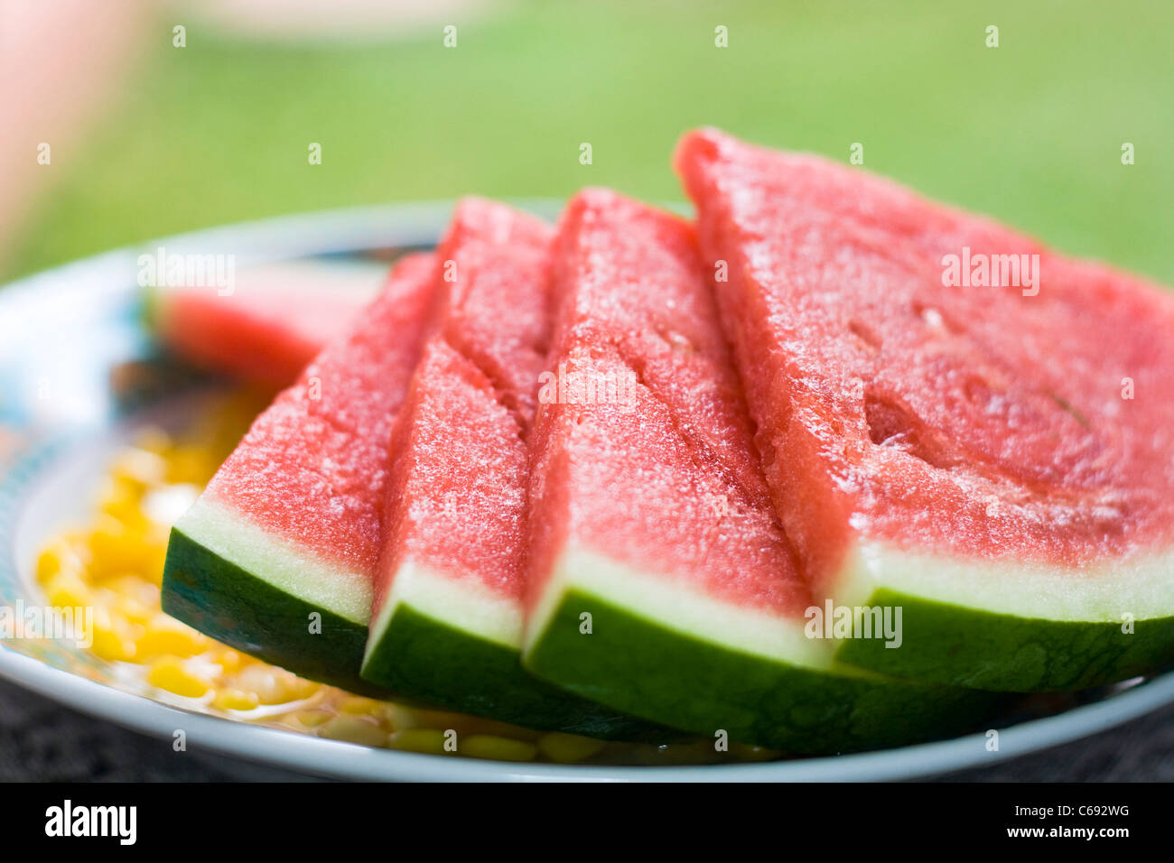 Fresh watermelon slices and maize Stock Photo - Alamy