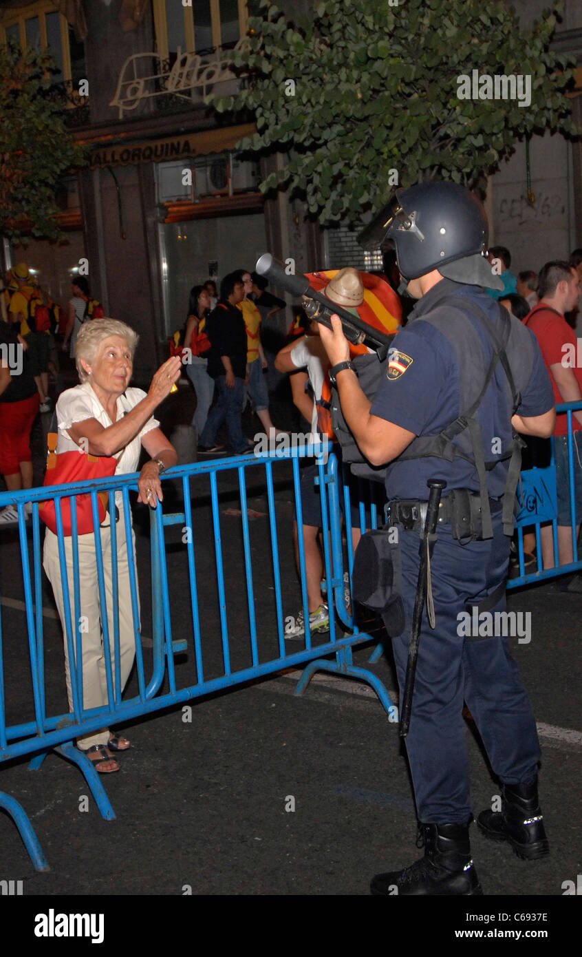Comical photo of an elderly woman talking to a policeman, after riots ...
